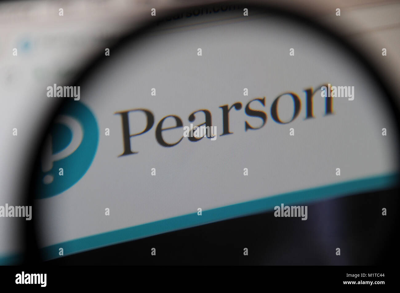 The Pearson website seen through a magnifying glass Stock Photo - Alamy