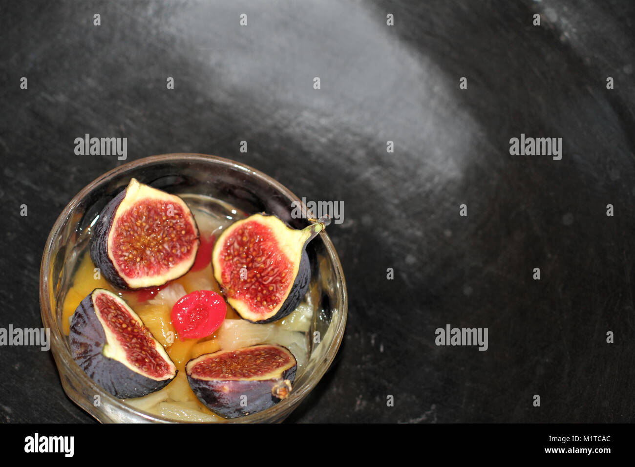 Diced fruit bowl with figs cut in half Stock Photo - Alamy