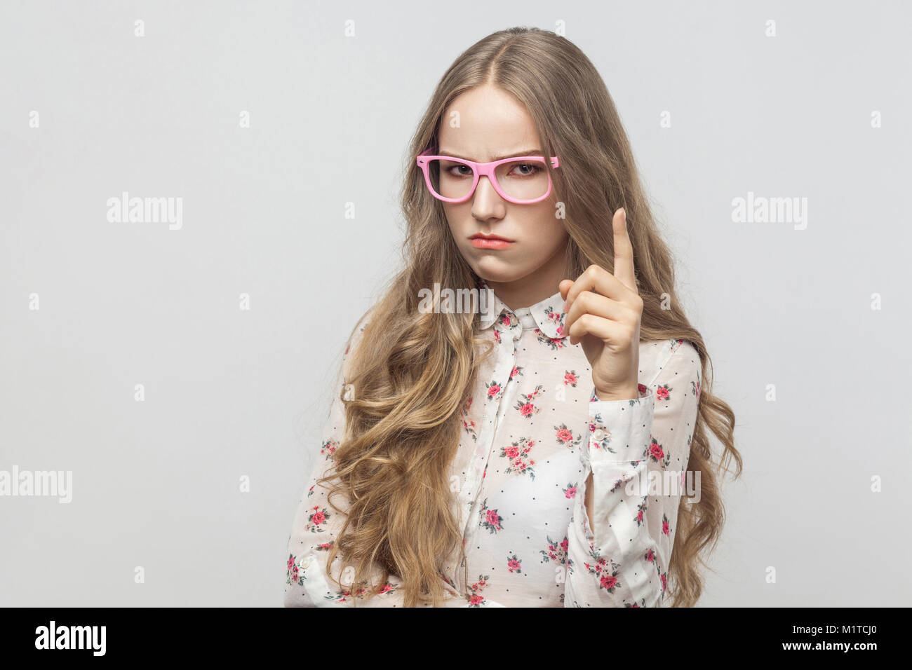 Hey! I'm seriously! Warning sign. Teenager girl looking at camera with ...