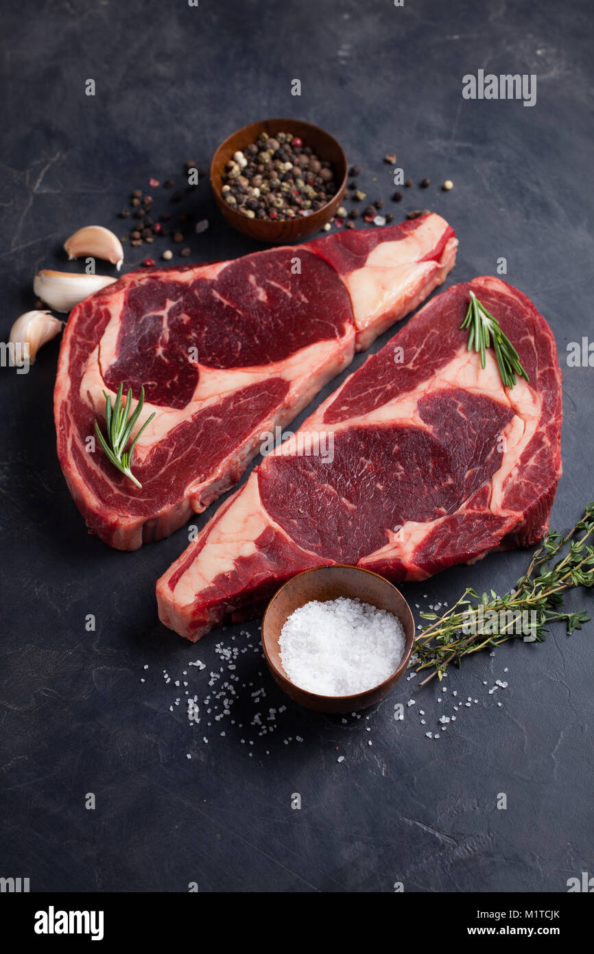 Raw fresh marbled meat Steak Ribeye Black Angus on black marble ...