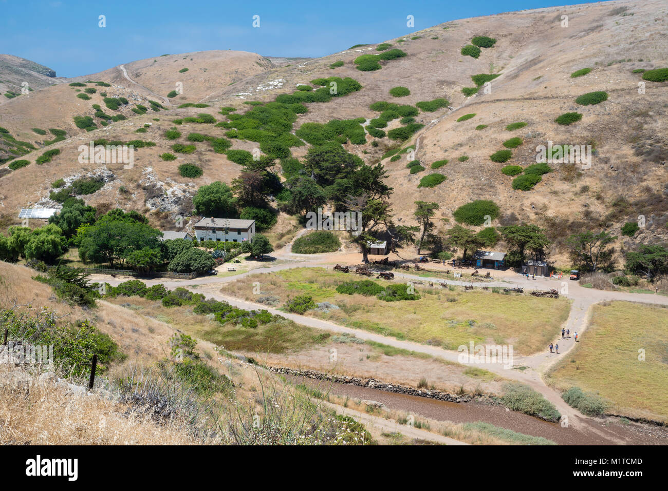 Visitors walk around the former Scorpion Ranch, which is now the ...