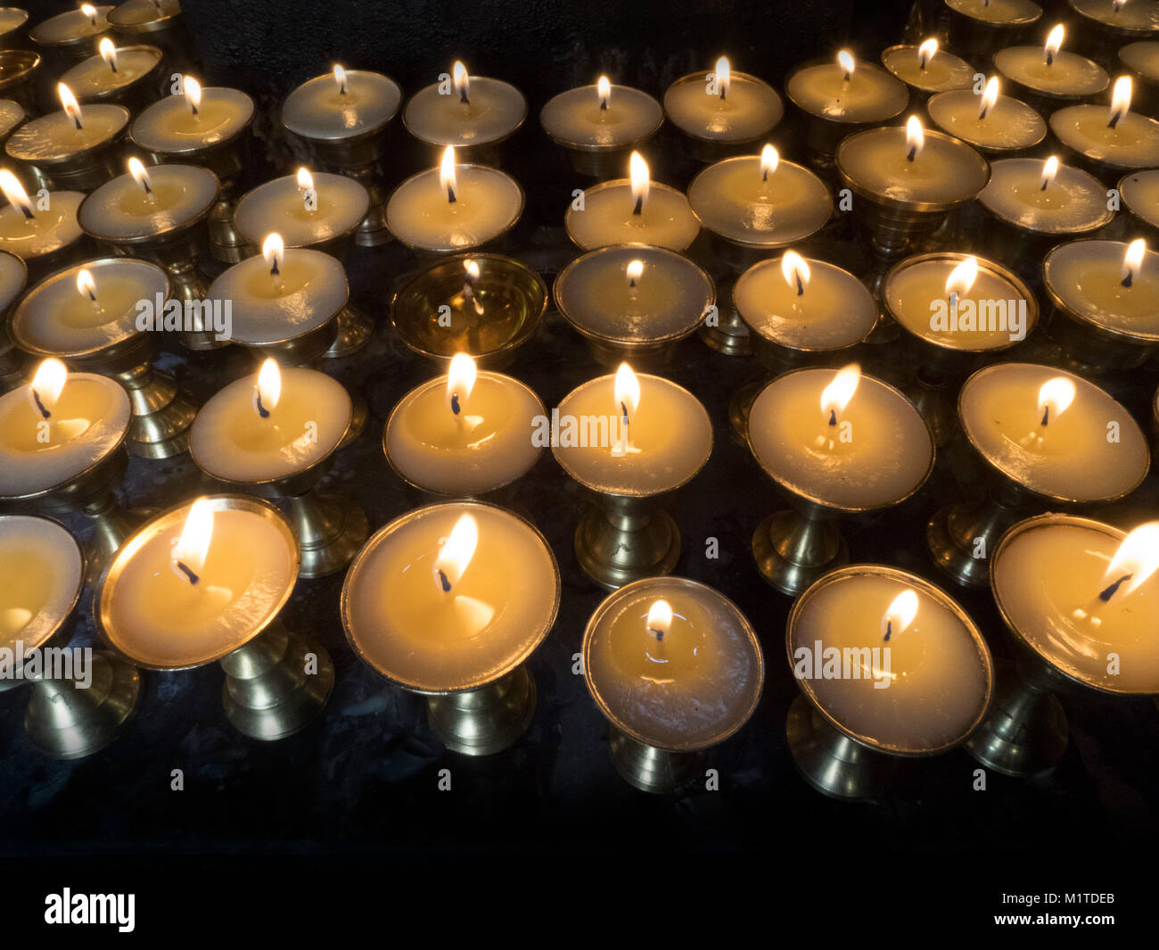 Burning with festive lights, oiled Tibetan prayer lamps to the Buddhist ...