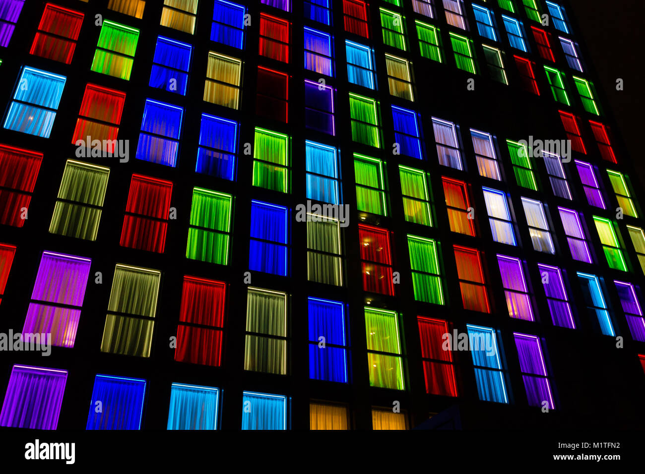 Colored windows texture. Windows illuminated by neon lights background ...