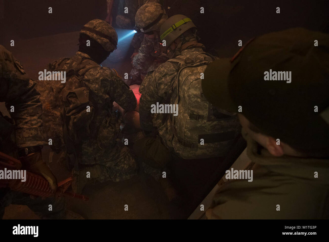 A U.S. Army combat medic instructor looks on to soldiers from the West ...