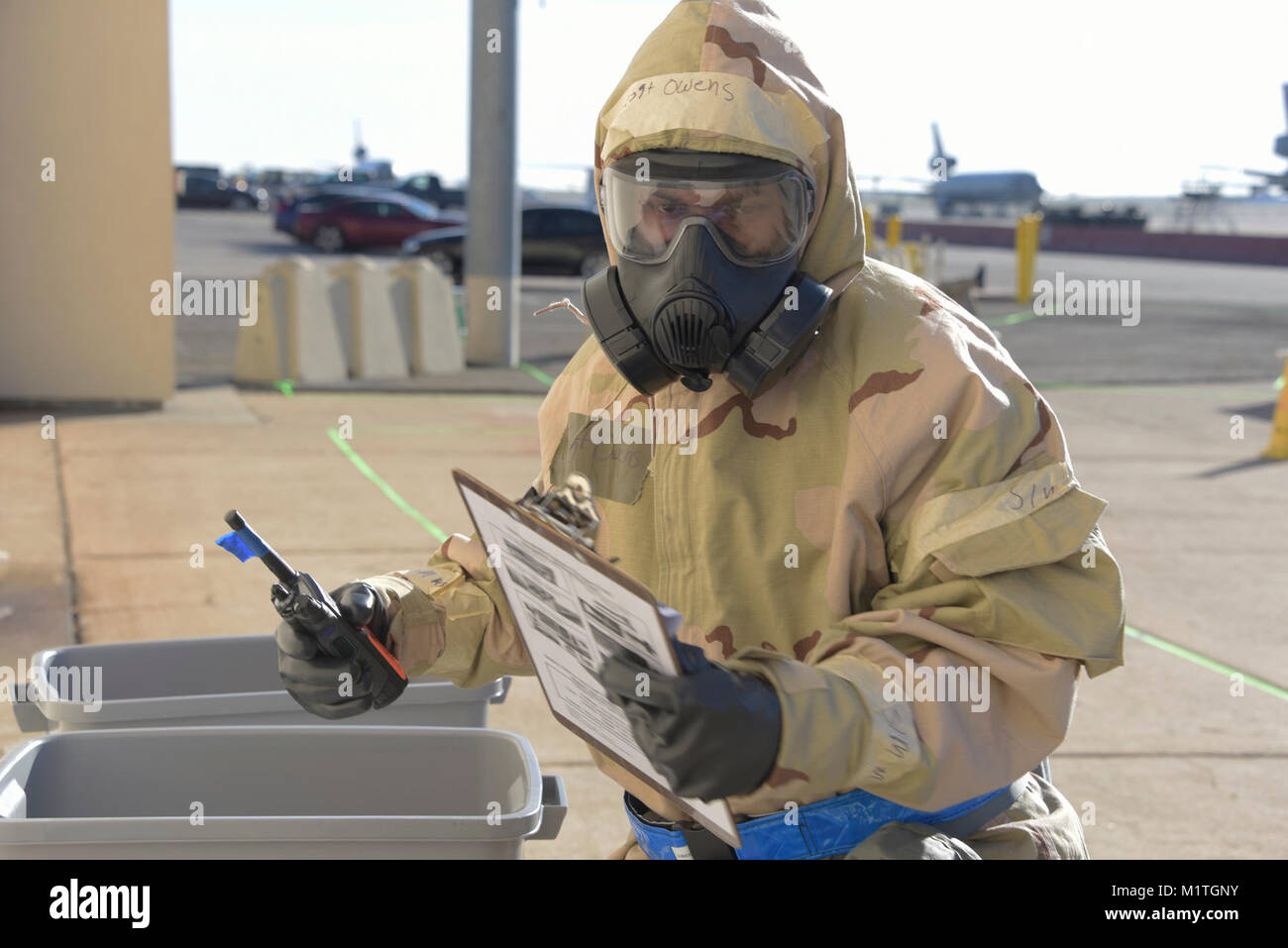 An Airman processes through a decontamination zone during a readiness ...