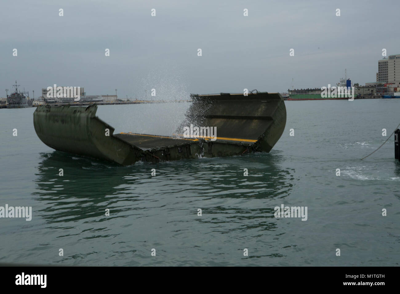 An Improved Ribbon Bridge (IRB) bay springs open after Marines with ...