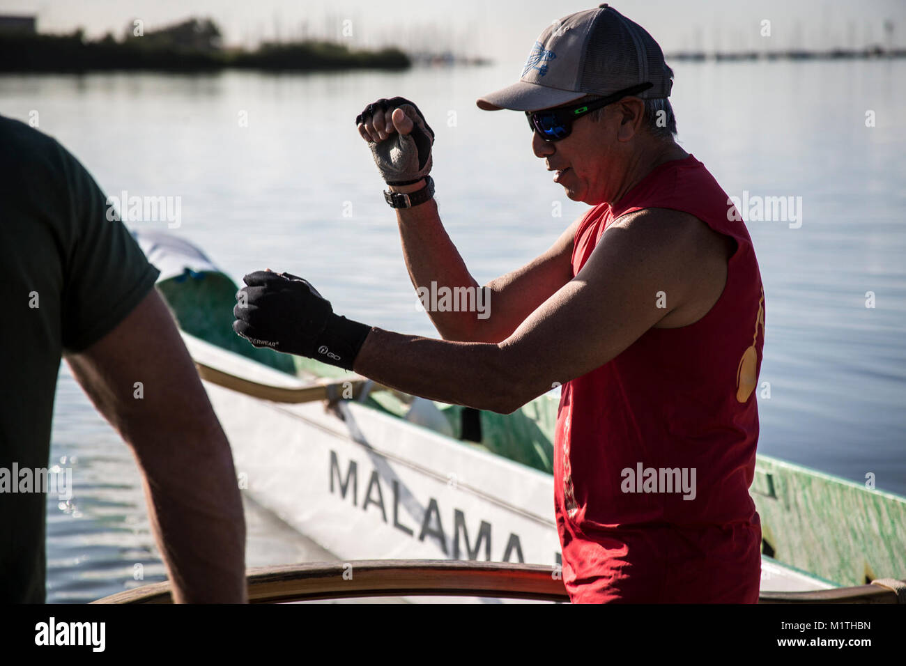 Coach and steersman of the Ka Mamala Hoe Canoe Club demonstrates proper ...