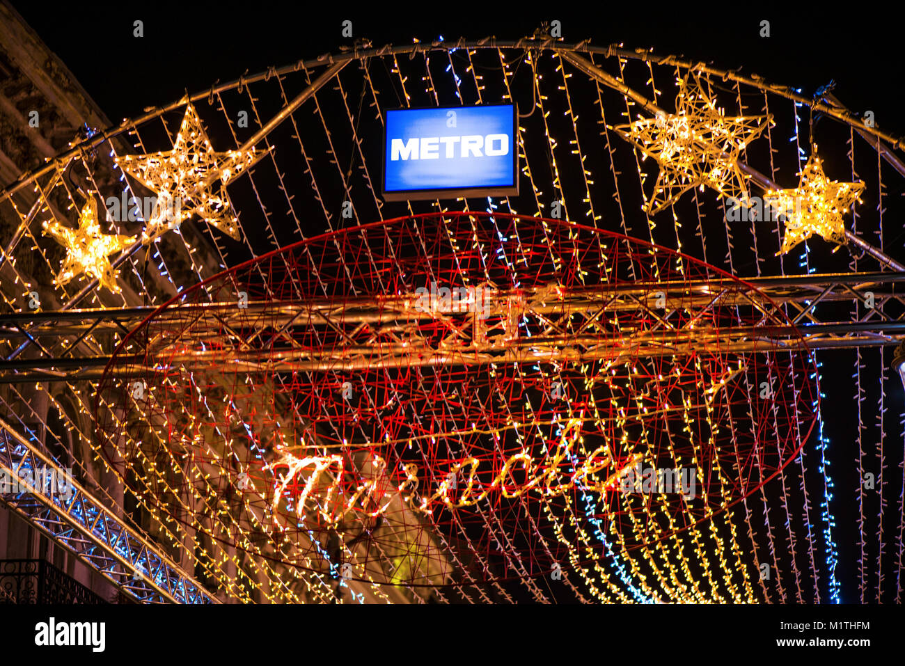 Metro sign and light stripes on dark, romantic night sky background ...