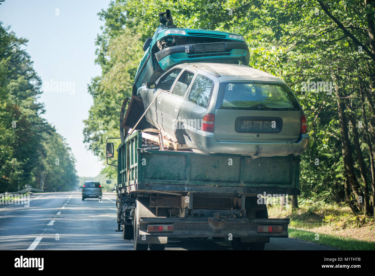 Two crashed cars after accident being transported by tow truck on ...
