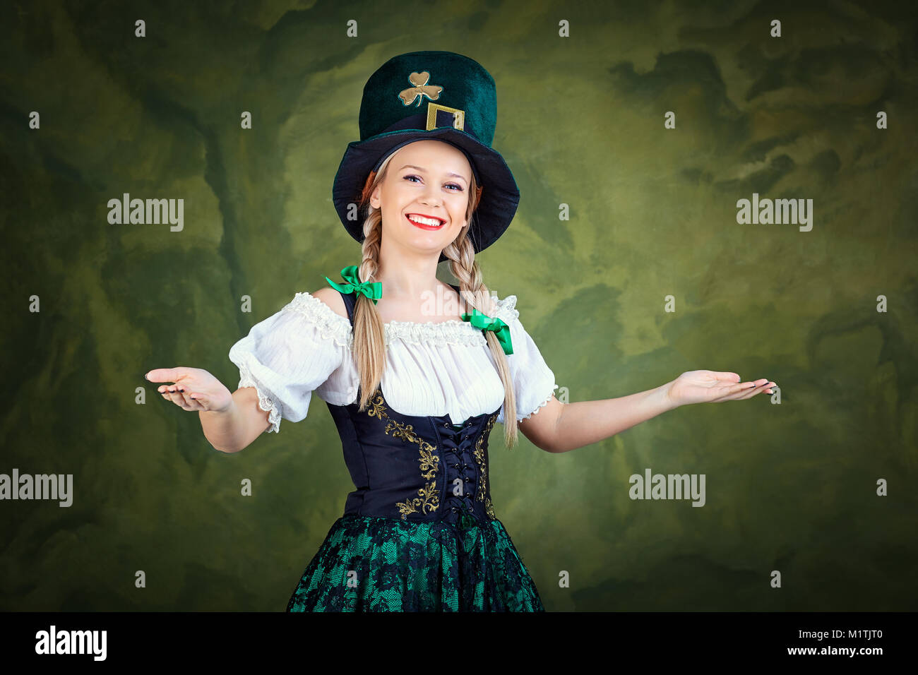 The girl in the suit of St. Patrick is welcome on a green backgr Stock ...