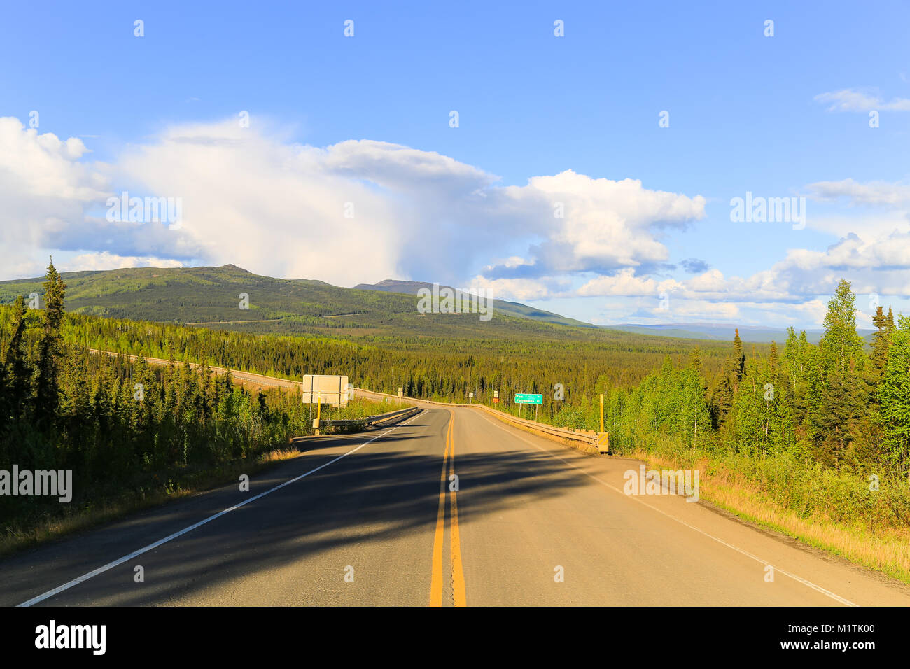 From North to South - driving on Elliot Highway through green hills to ...