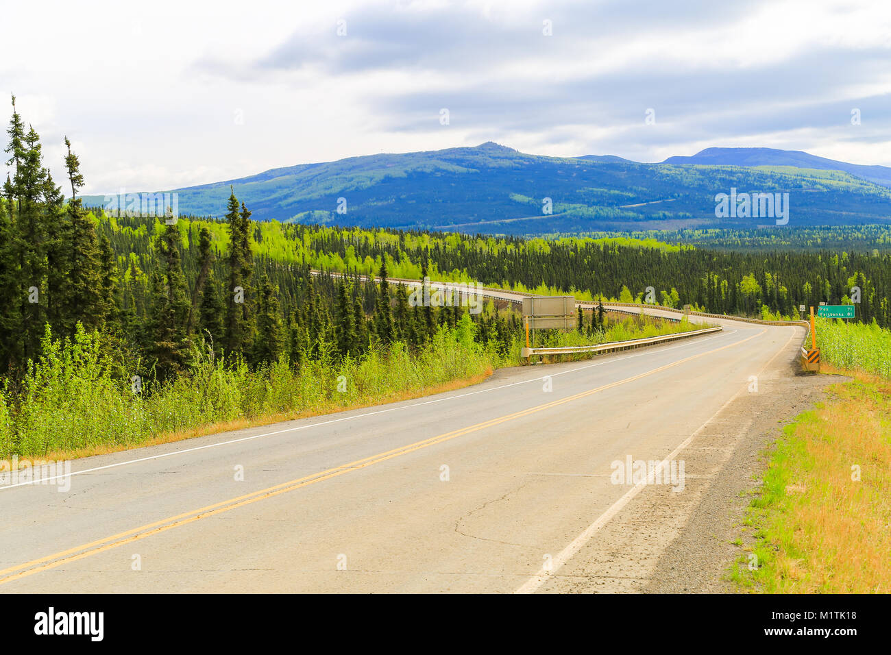 From North to South - driving on Elliot Highway through green hills to ...