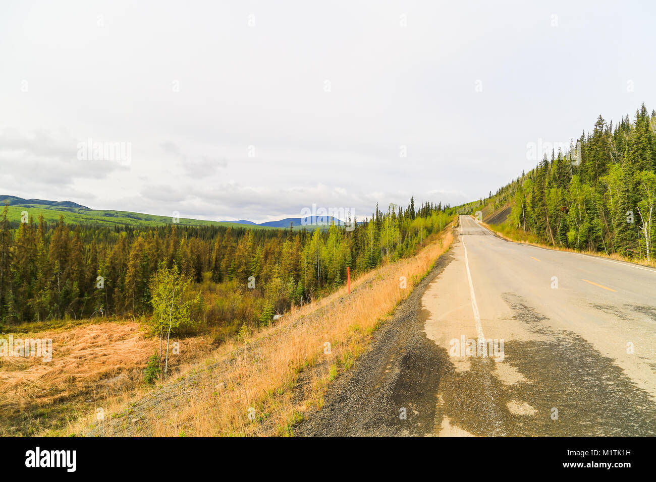 From North to South - driving on Elliot Highway through green hills to ...