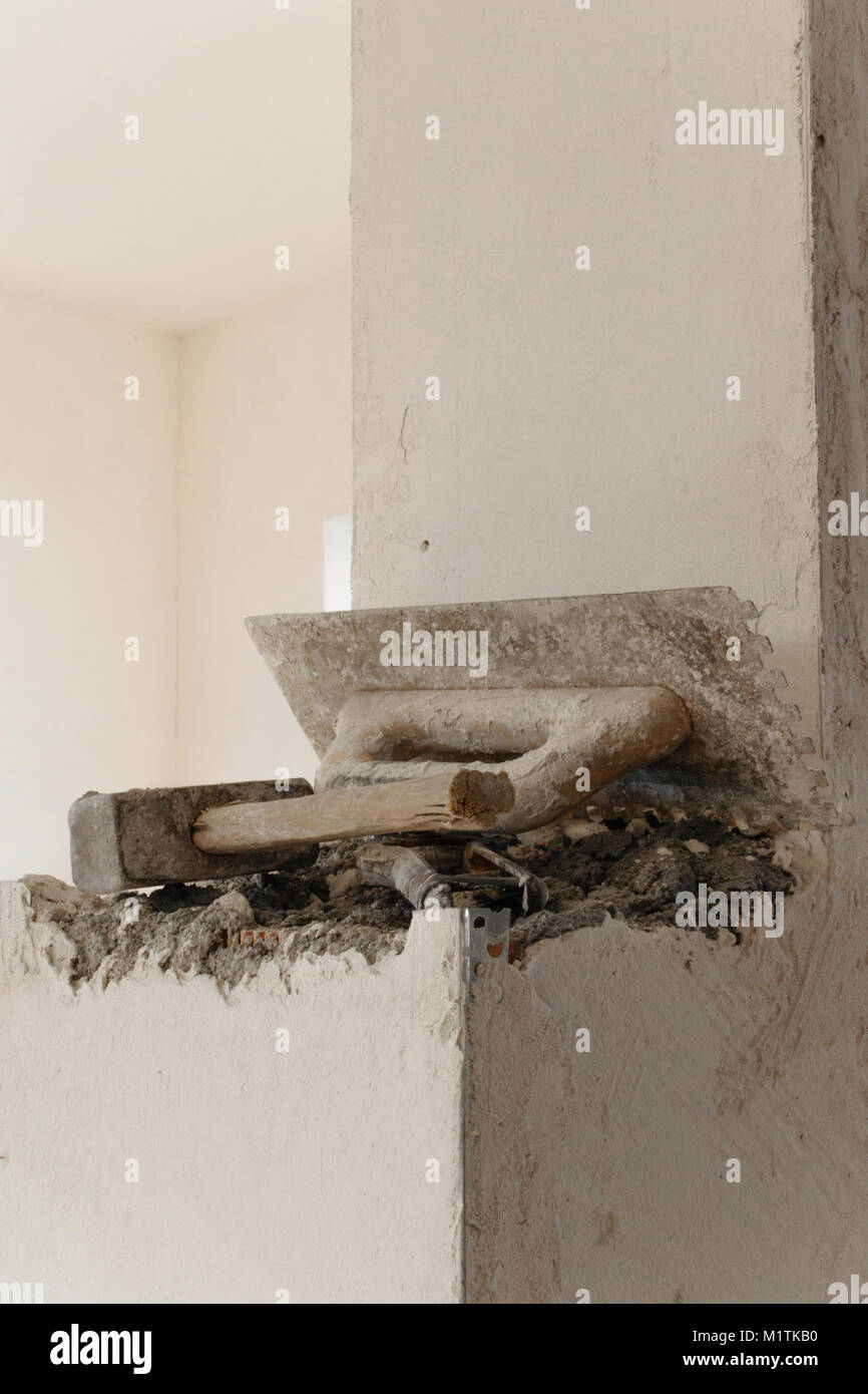 New house construction - masonry tools on the wall, space for text ...