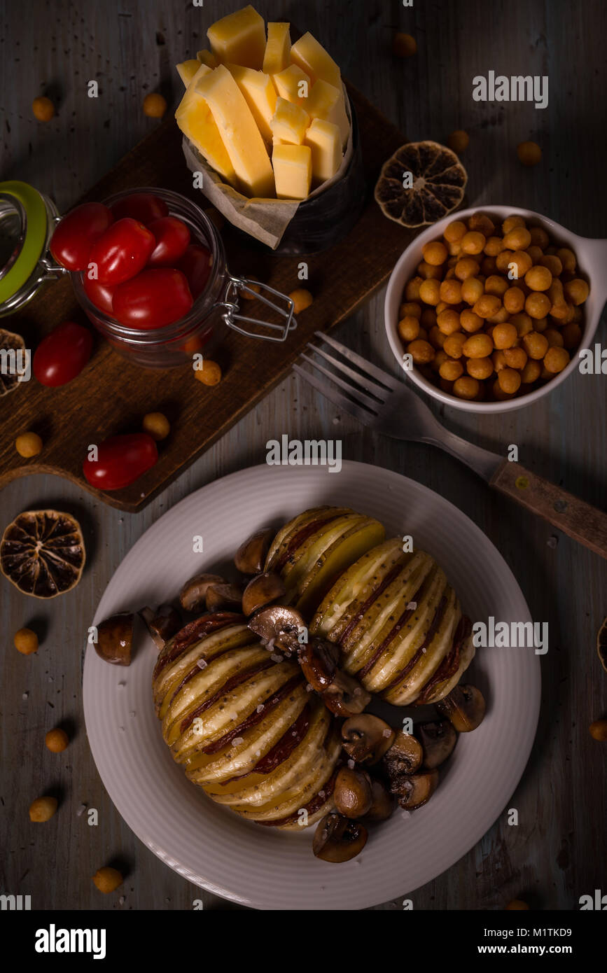Vertical photo with top view on two roasted and sliced whole potatoes ...