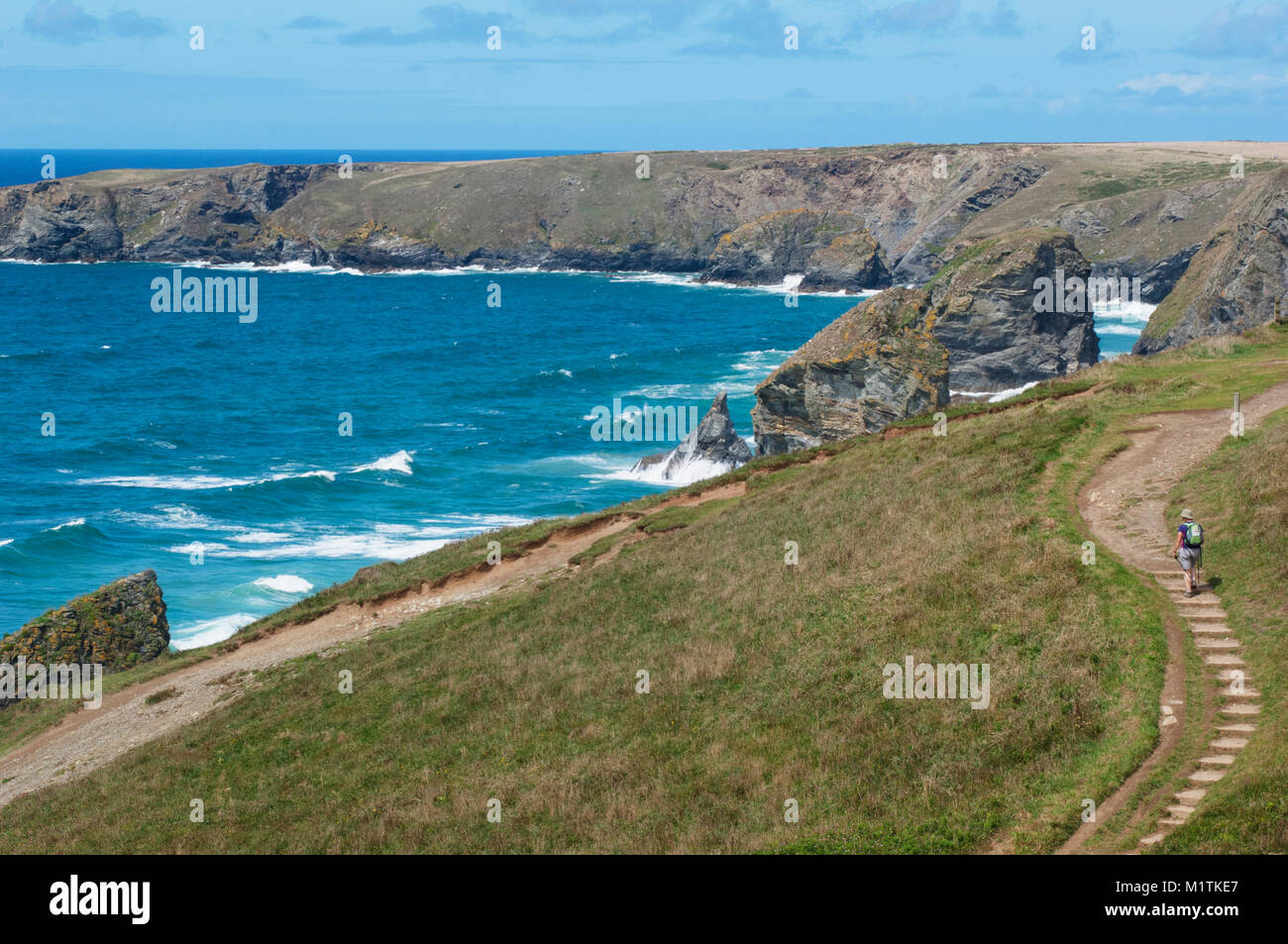Single walker enjoying the North Cornish footpath at Bedruthan Steps ...