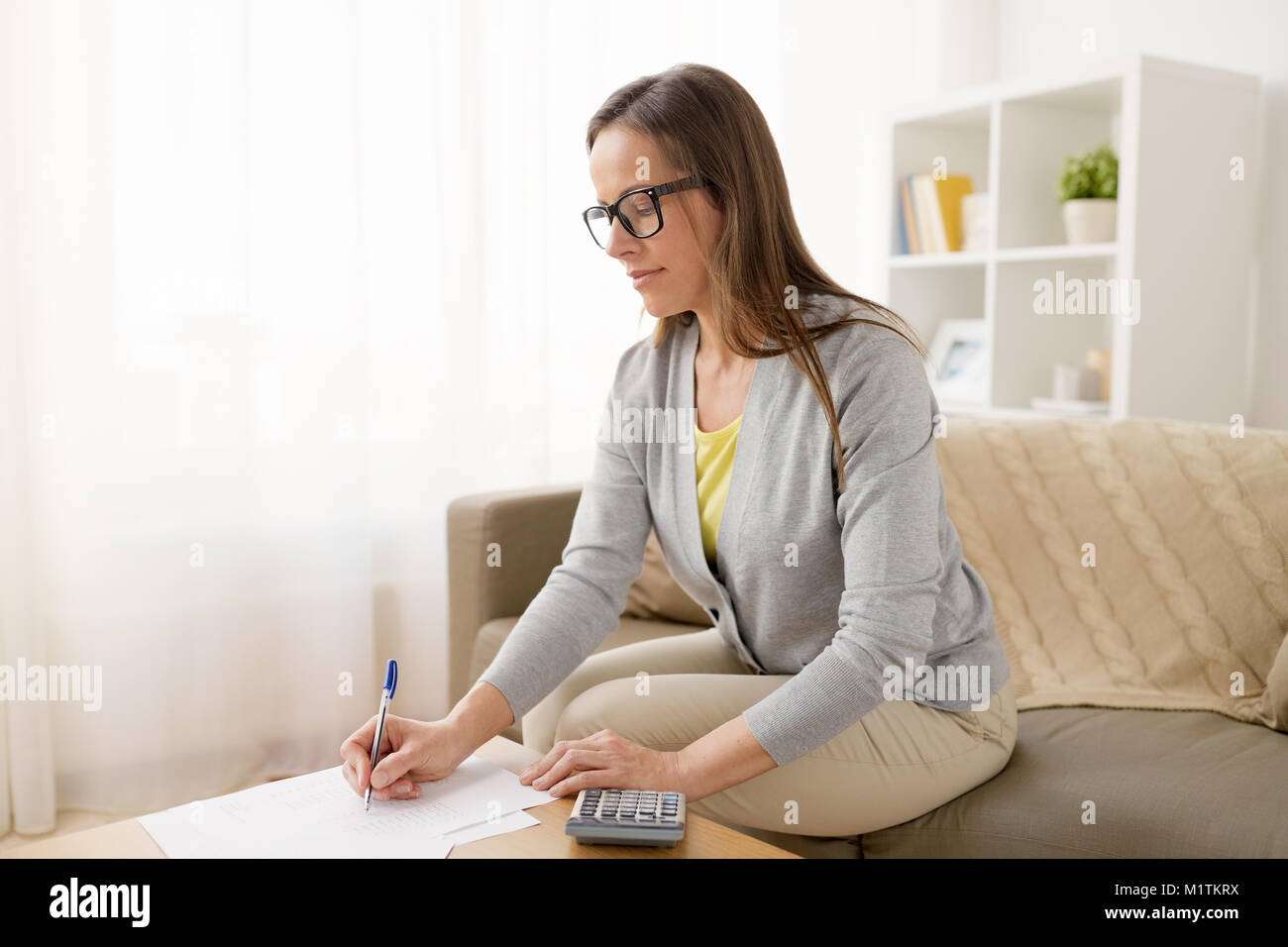 Woman calculator hi-res stock photography and images - Alamy