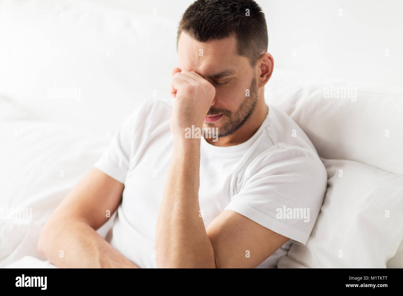 stressed man in bed at home Stock Photo - Alamy