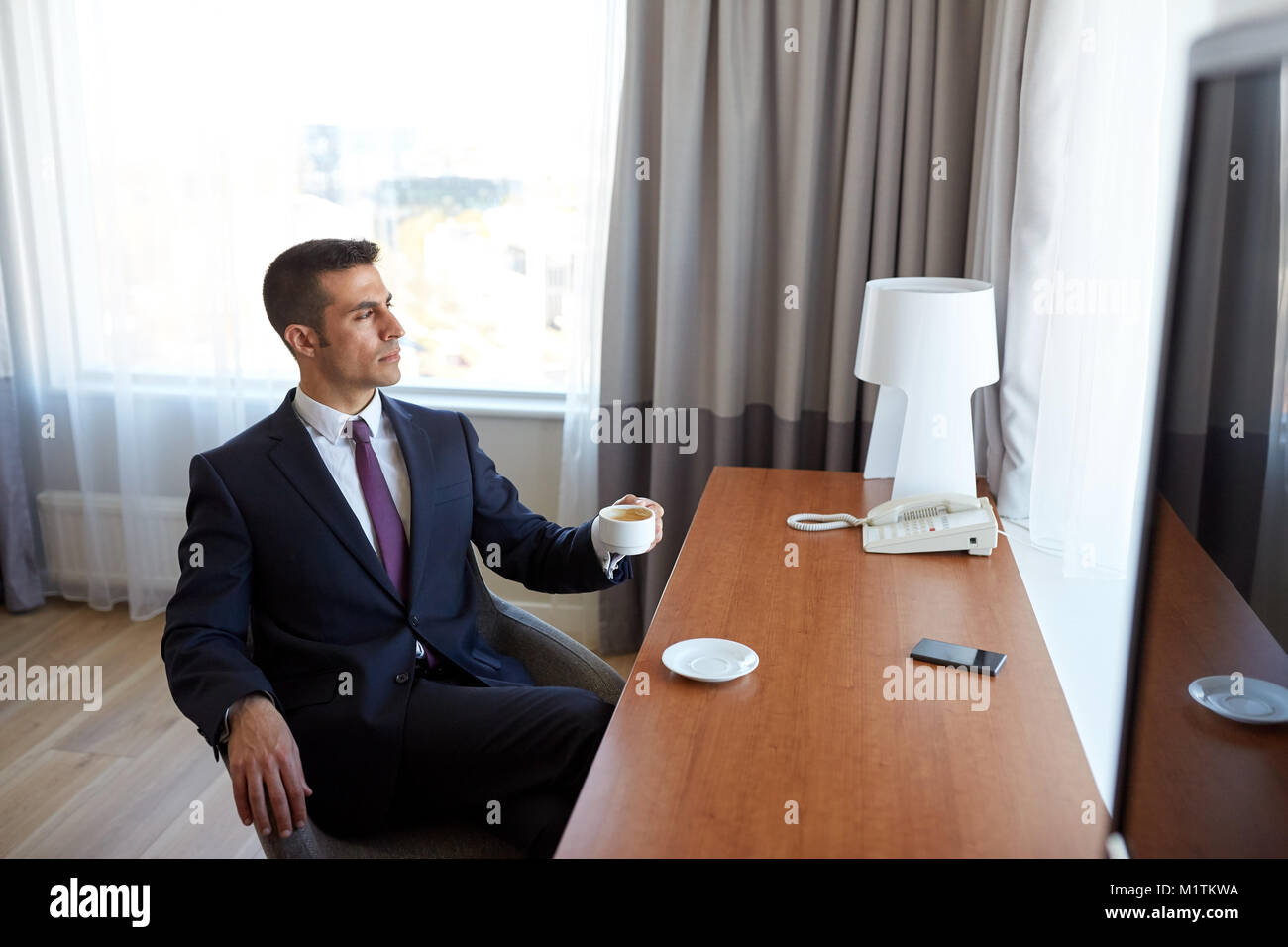 businessman drinking coffee at hotel room Stock Photo - Alamy