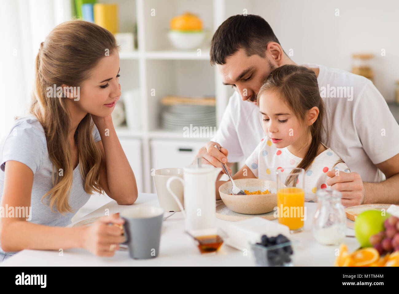 happy family having breakfast at home Stock Photo - Alamy