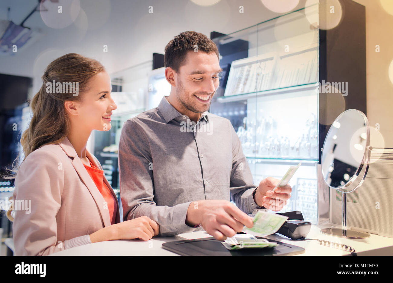 happy couple paying for purchase in store Stock Photo - Alamy