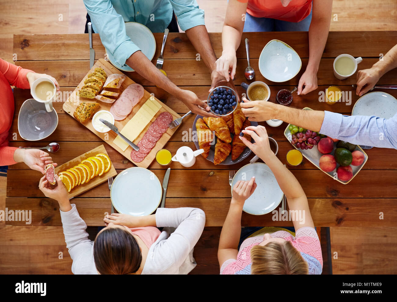 group of people having breakfast at table Stock Photo - Alamy
