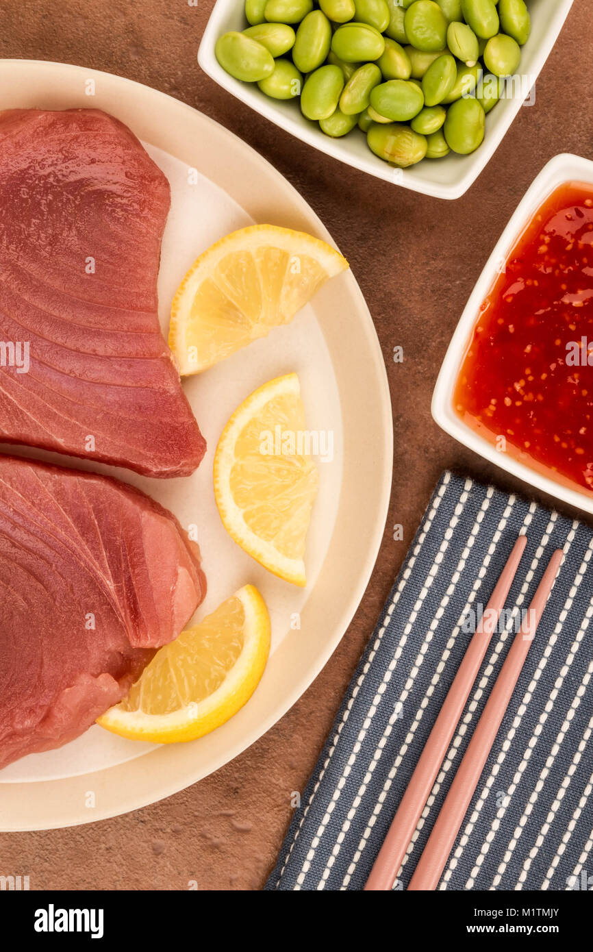 Fresh Raw Uncooked Yellow Fin Tuna Steaks With Lemon Slices Against A ...
