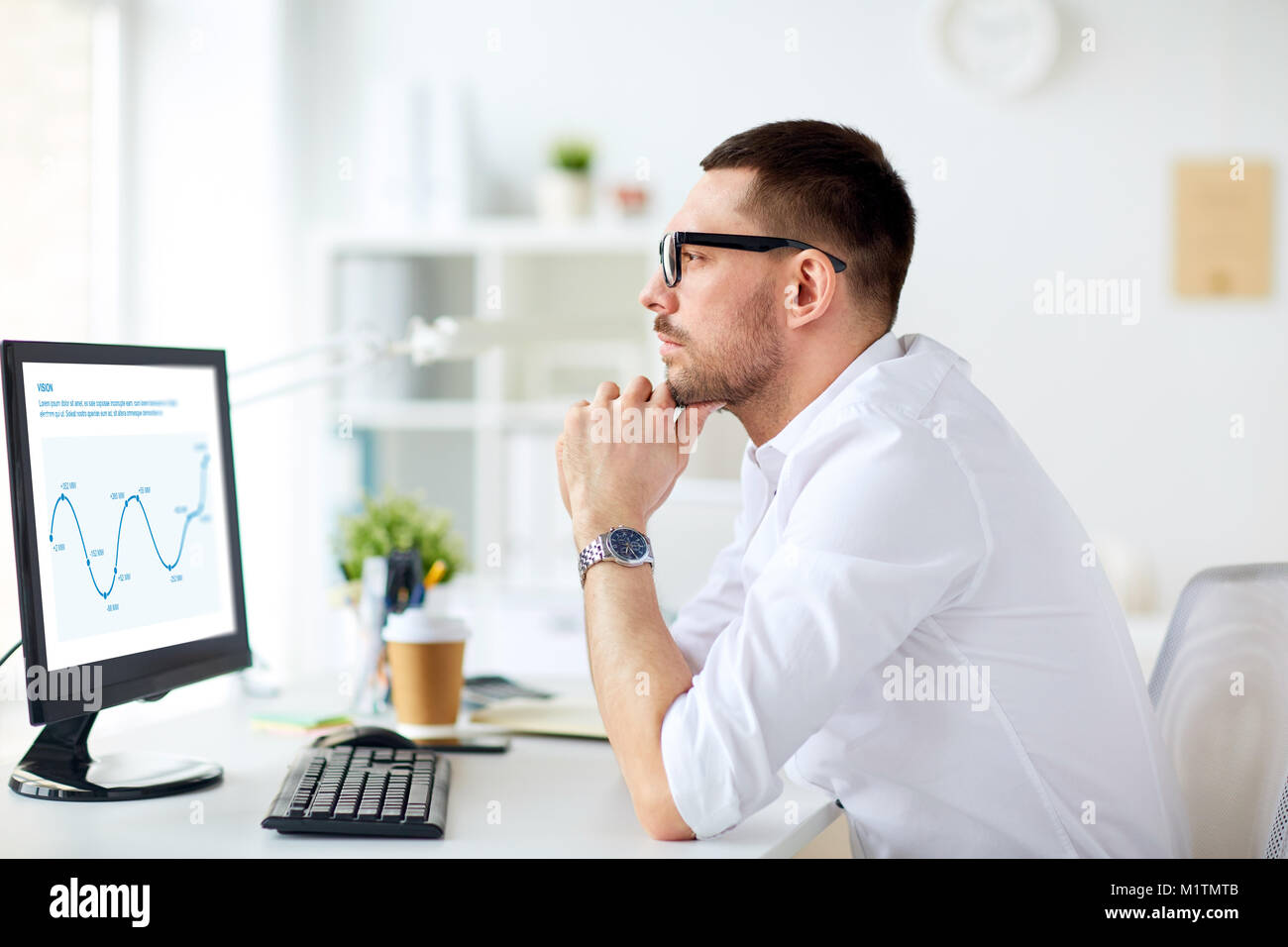 businessman with charts on computer at office Stock Photo - Alamy