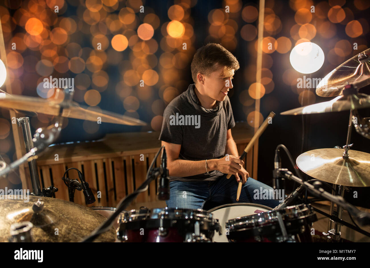 musician playing drum kit at concert over lights Stock Photo - Alamy