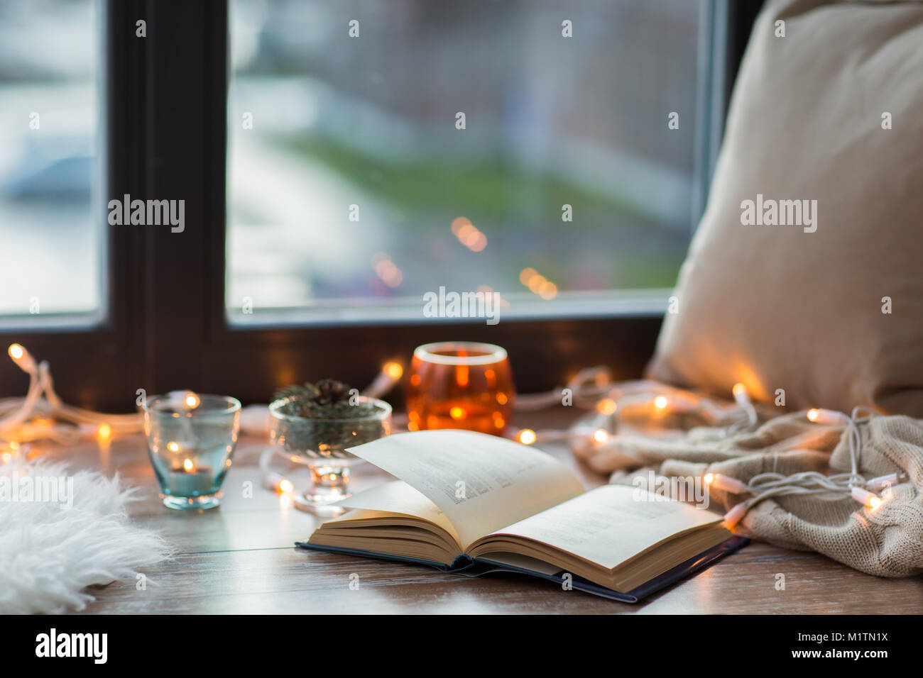 Candle book on sill window hi-res stock photography and images - Alamy