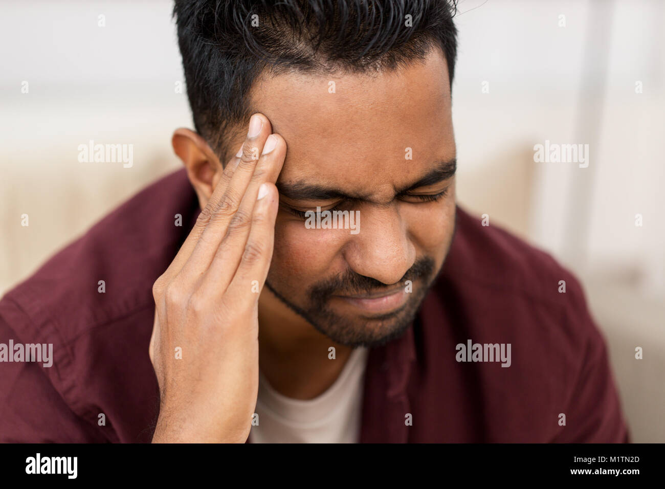 close up of man suffering from head ache at home Stock Photo - Alamy