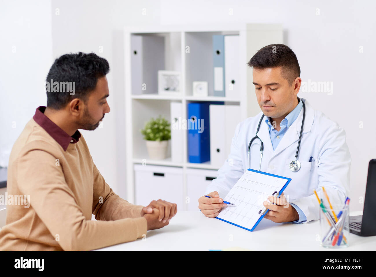 happy doctor and male patient meeting at hospital Stock Photo - Alamy