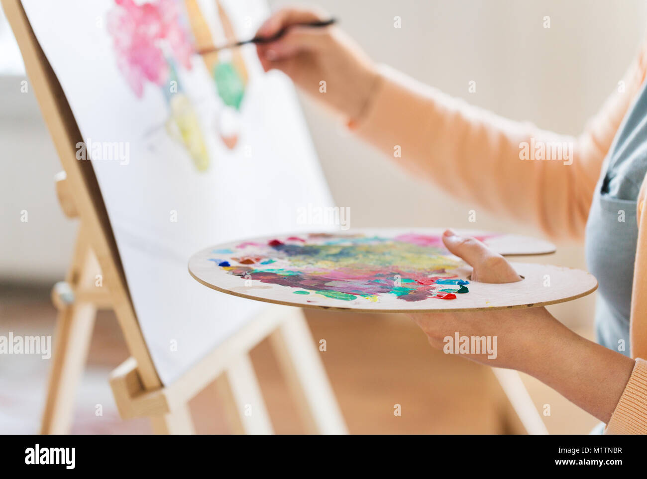 artist with palette and brush painting at studio Stock Photo - Alamy