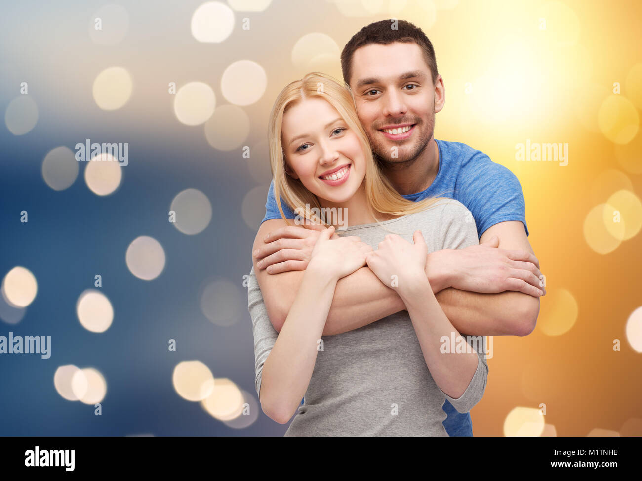 happy couple hugging over lights background Stock Photo - Alamy