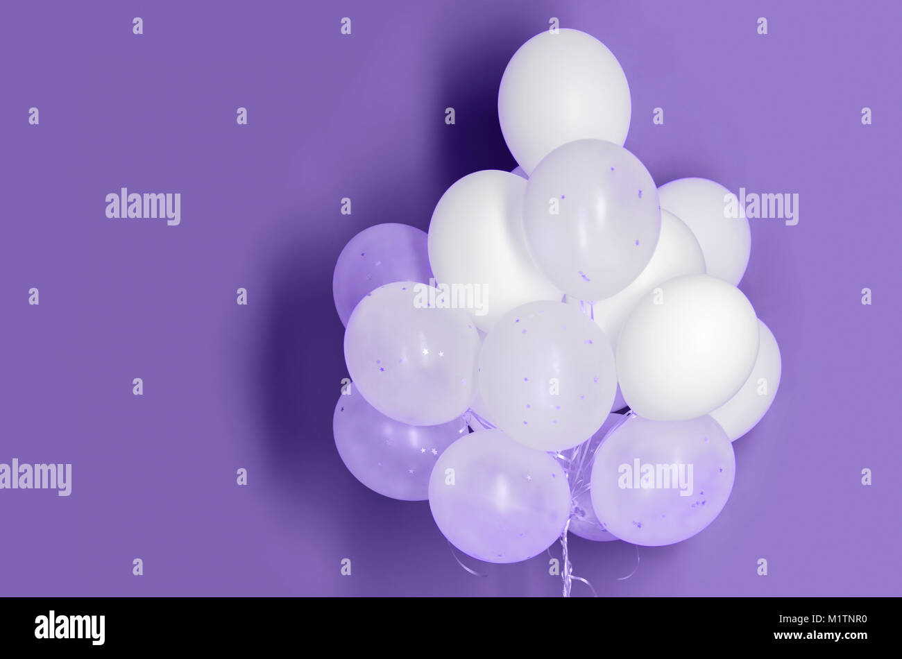 white helium balloons on ultra violet background Stock Photo - Alamy