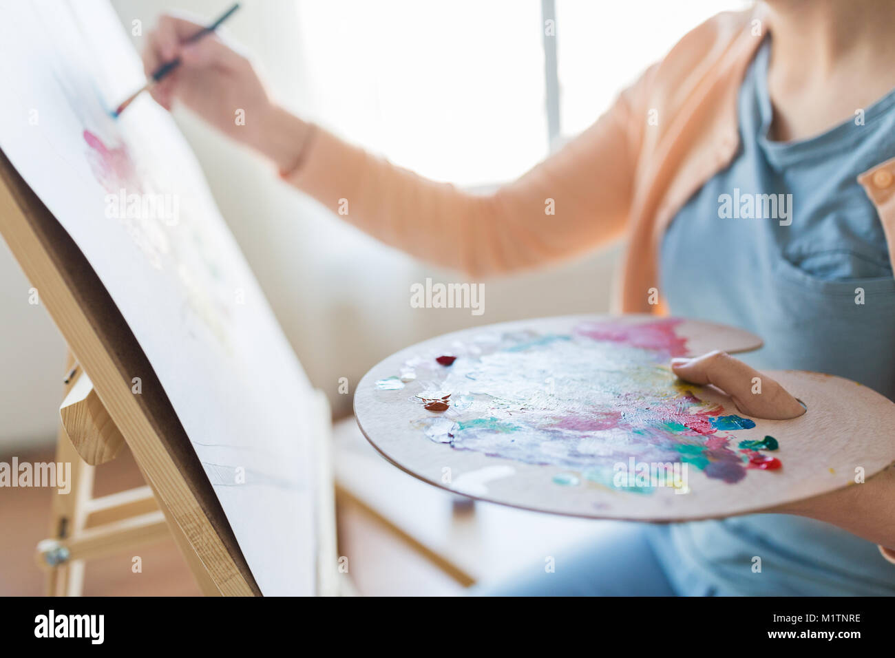 artist with palette and brush painting at studio Stock Photo - Alamy