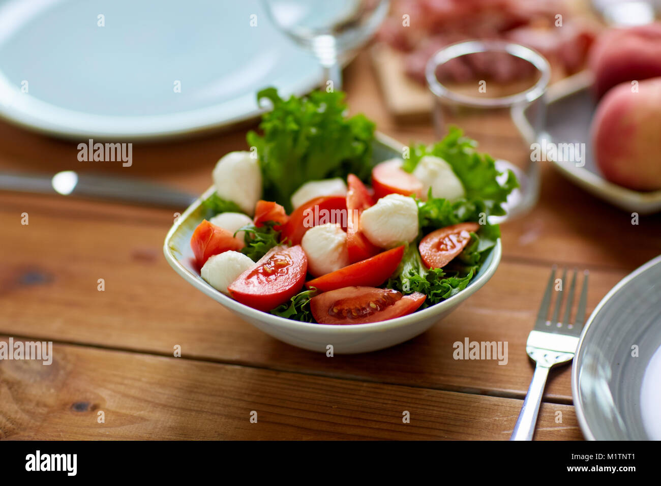 vegetable salad with mozzarella on wooden table Stock Photo - Alamy