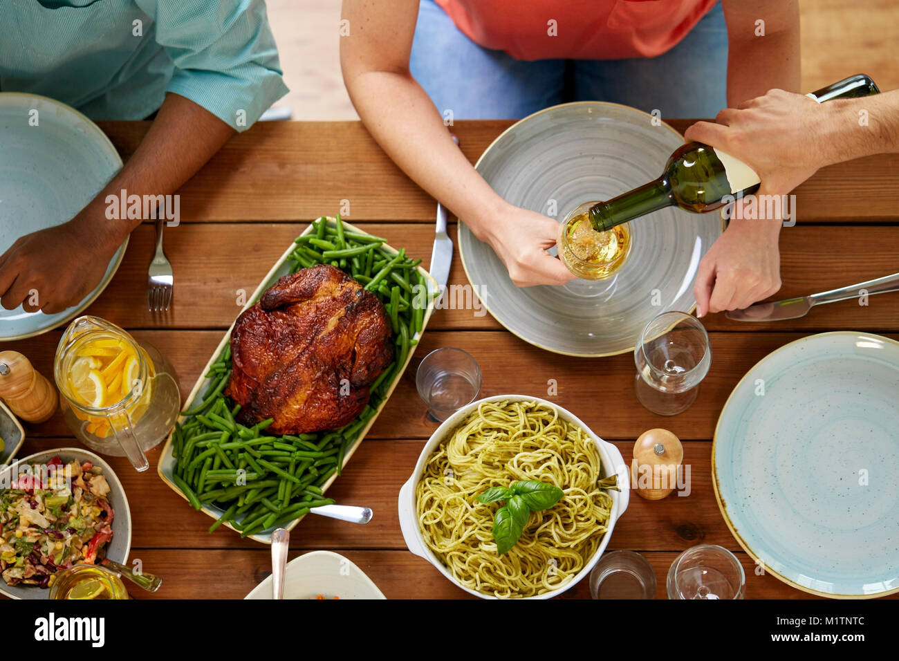 Hand pouring wine couple hi-res stock photography and images - Alamy