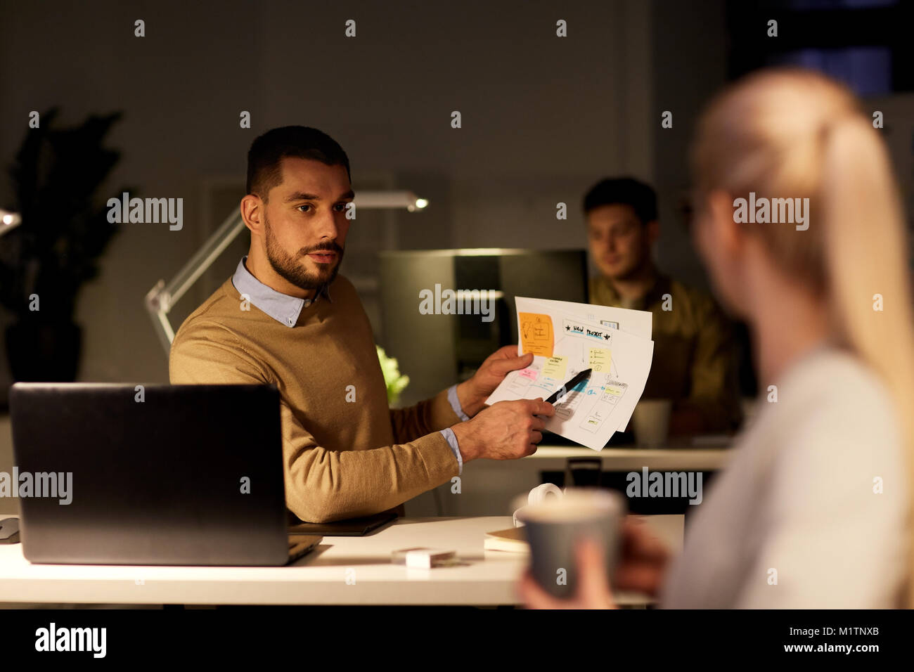 colleagues discussing project late in office Stock Photo - Alamy