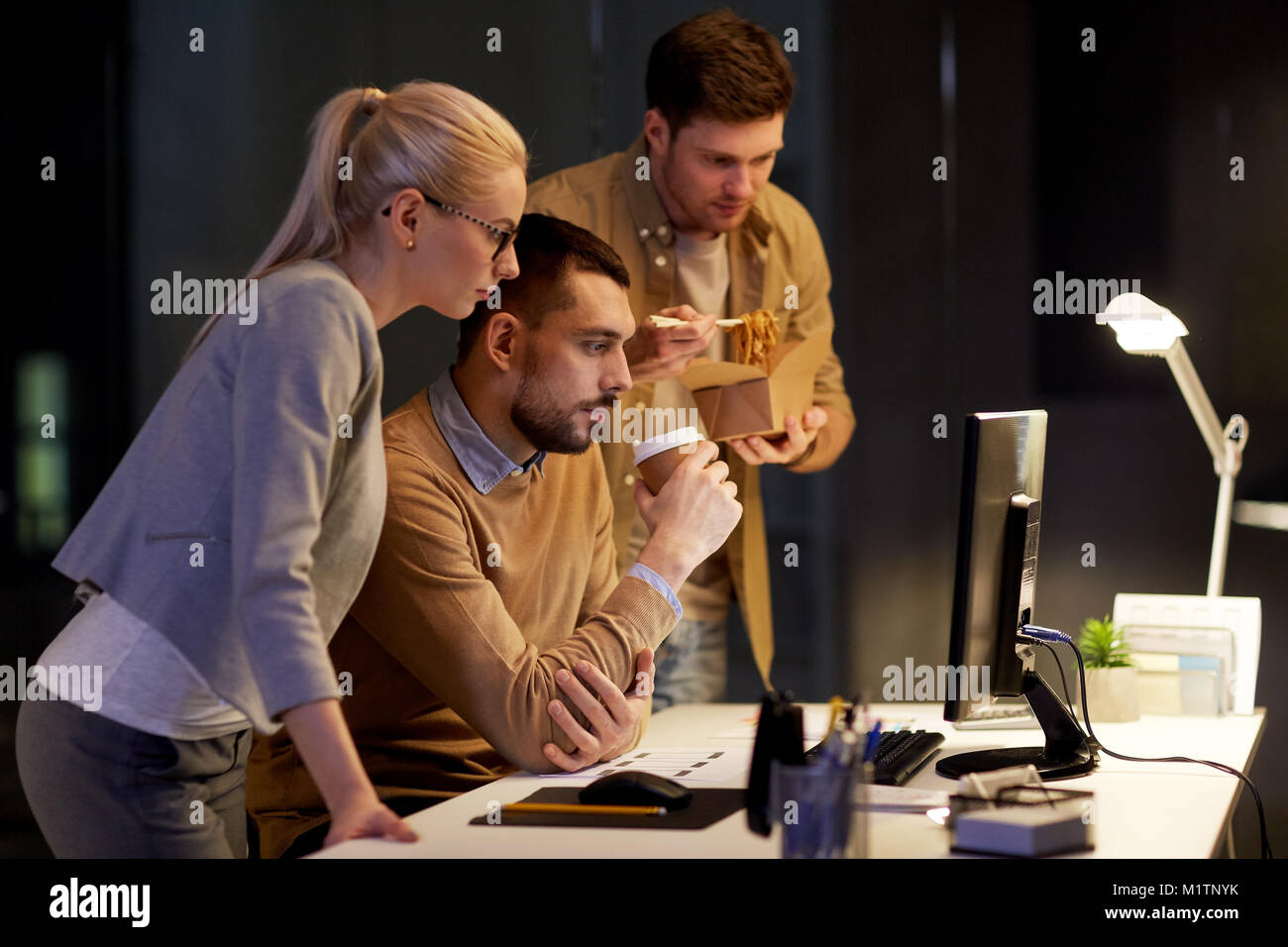 business team with computer working late at office Stock Photo - Alamy