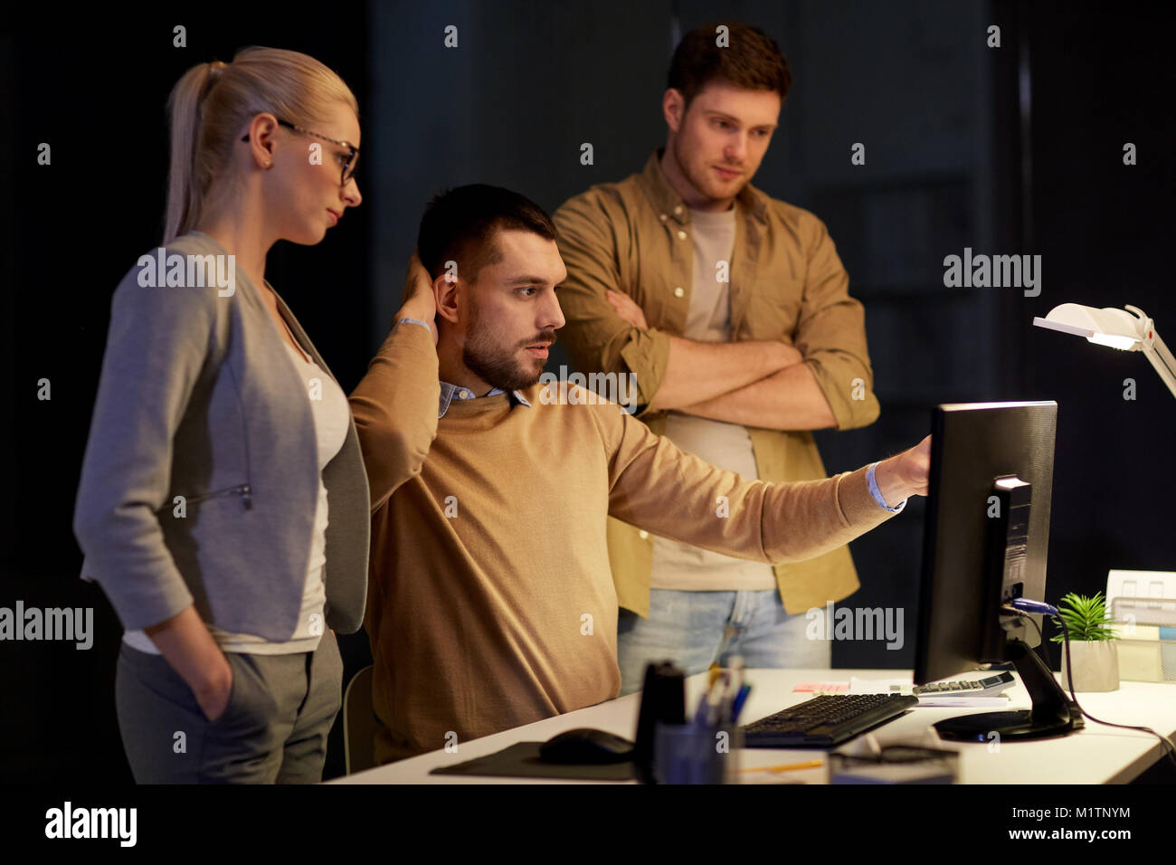 business team with computer working late at office Stock Photo - Alamy
