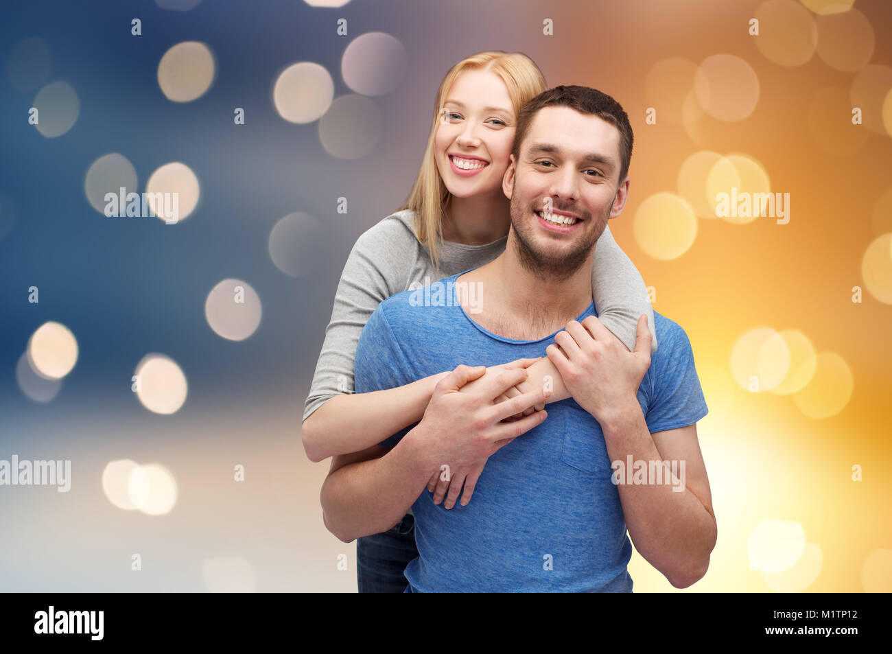 happy couple hugging over lights background Stock Photo - Alamy