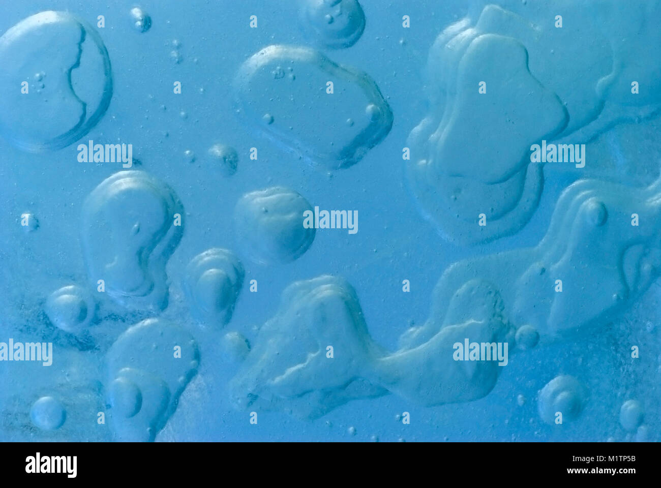 background, texture: cold blue opaque ice surface with the bumps of ...