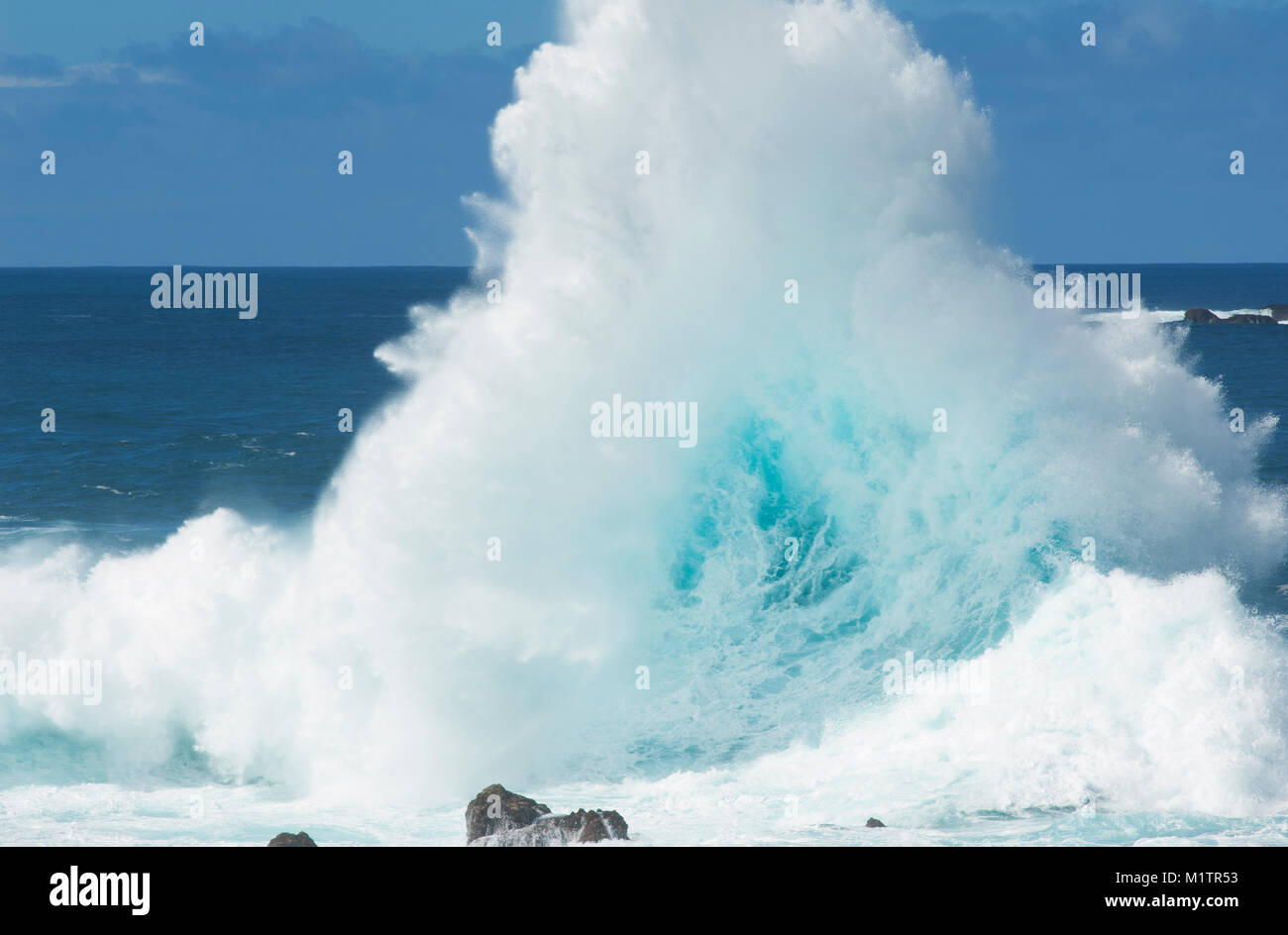 Large wave breaking over a reef - John Gollop Stock Photo - Alamy