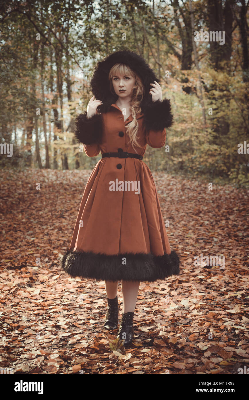 Woman in vintage red coat in autumn leaves Stock Photo - Alamy