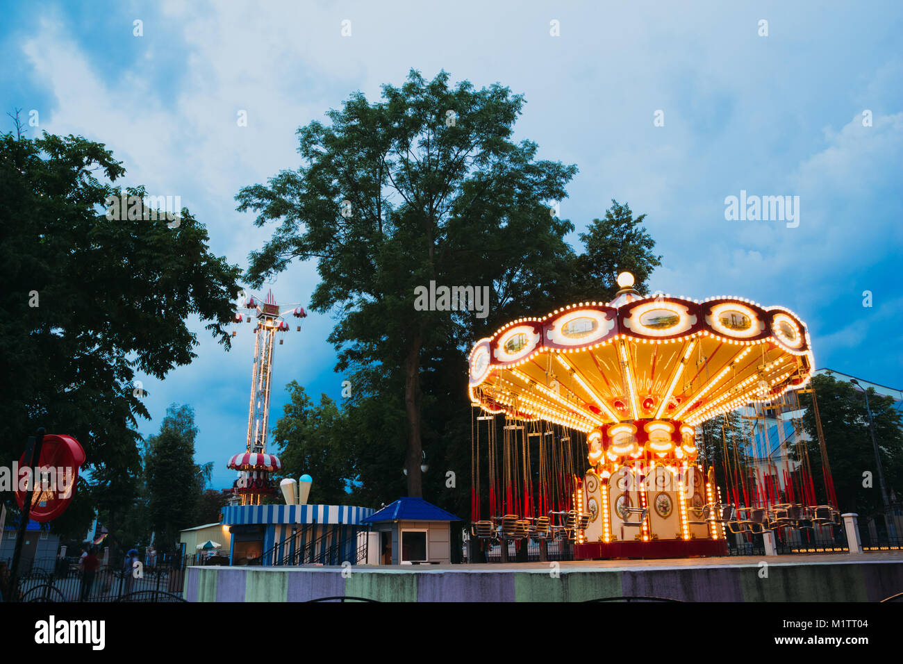Children's Carousel at an amusement park in the trees Stock Photo - Alamy