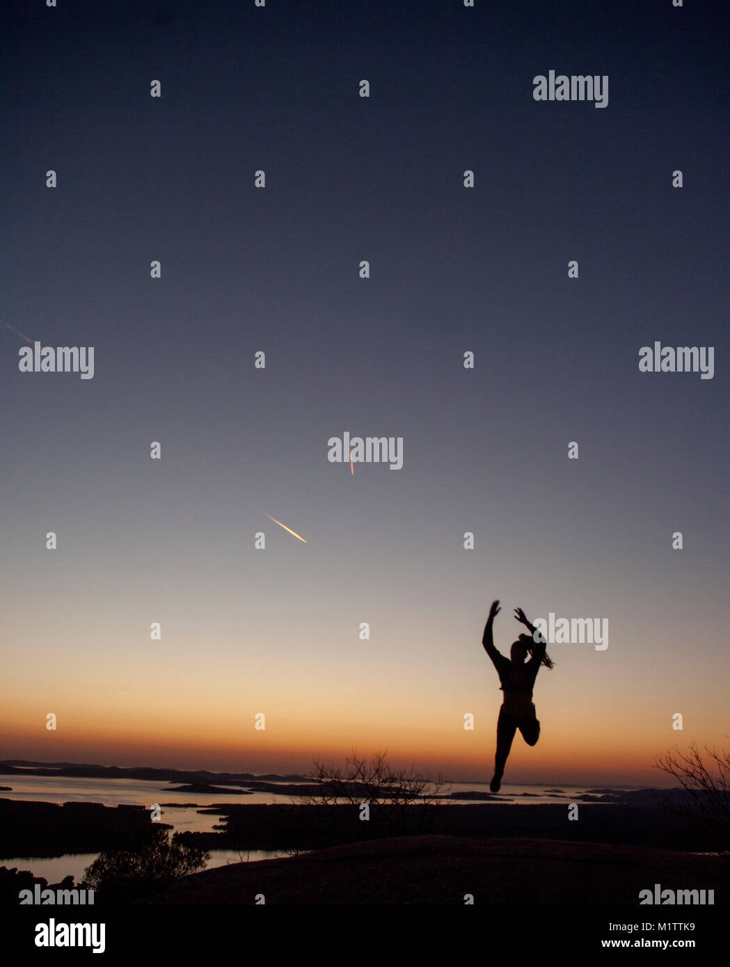 girl jumping to the sky to reach the stars Stock Photo - Alamy