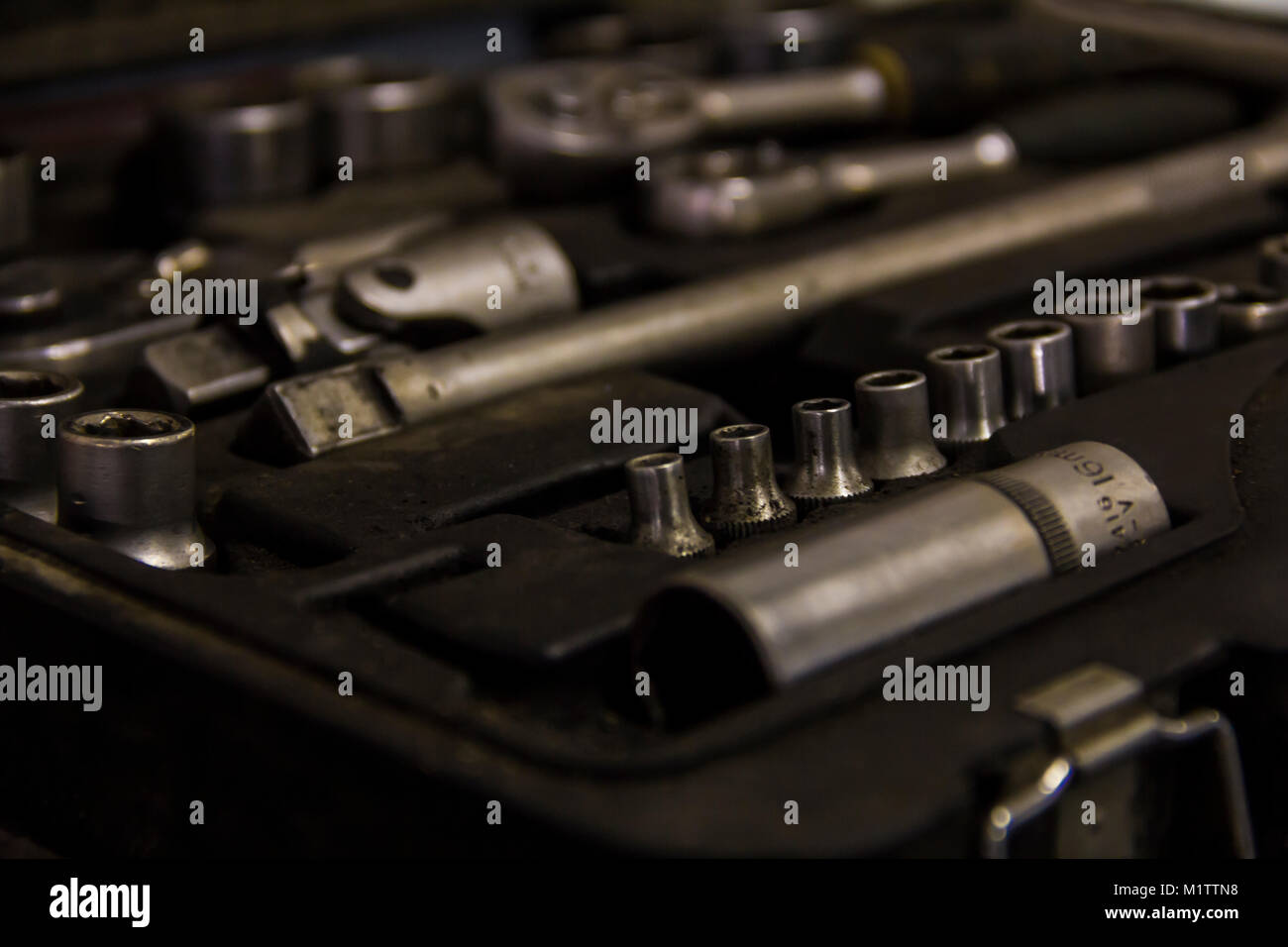 An untidy workbench full of greasy old tools set for repairing or ...