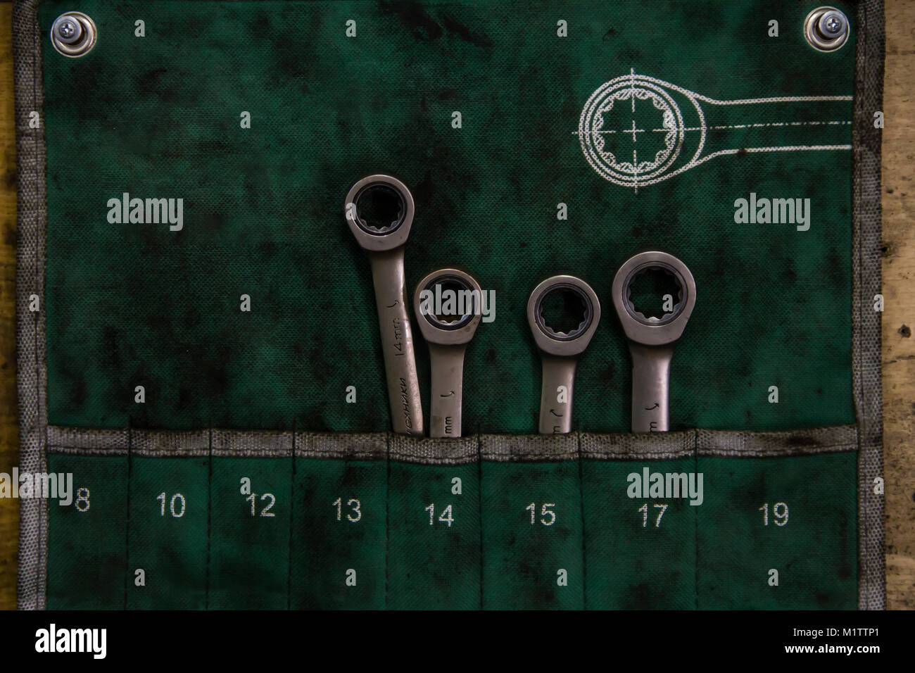 An untidy workbench full of greasy old tools set for repairing or ...