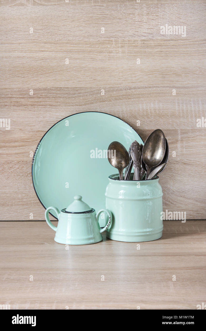 Turquoise crockery, tableware, dishware utensils and stuff on wooden ...